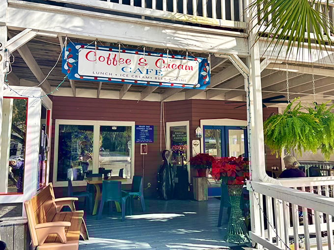 The inviting porch of Coffee & Cream Café feels like a warm Southern welcome—colorful chairs, swaying palms, and the promise of good coffee and even better conversation.