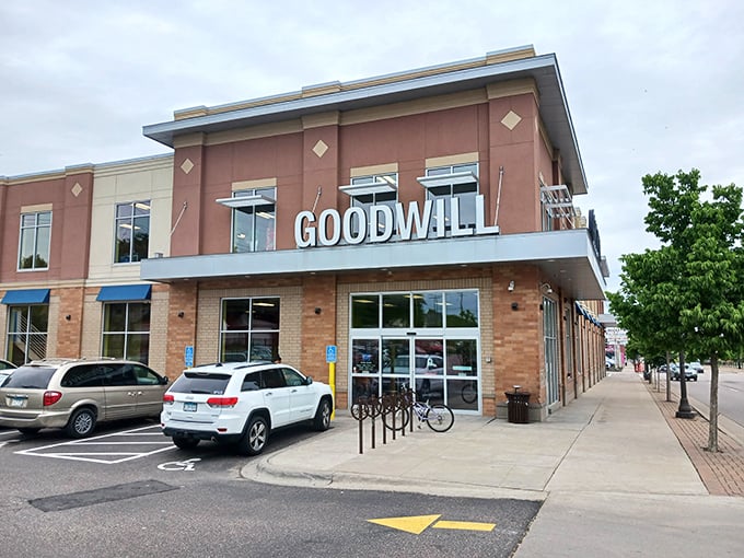 The modern brick facade of Goodwill on University Avenue stands like a beacon for treasure hunters, promising adventures in pre-loved merchandise behind those welcoming glass doors.