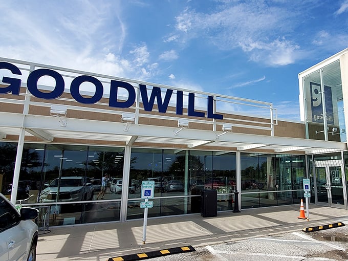 The sleek glass front of Bellevue’s Goodwill invites shoppers in with its familiar smiling logo and the promise of hidden treasures waiting inside.