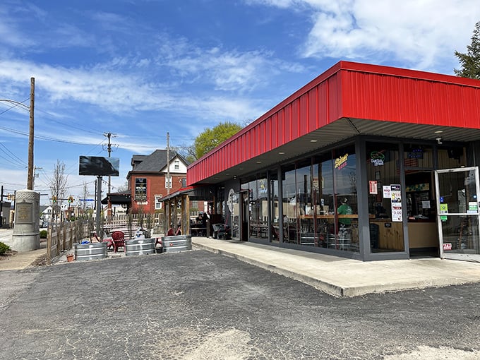 The bright red exterior of Off the Rails isn't just eye-catching—it's a beacon for barbecue lovers seeking smoky salvation in Verona.