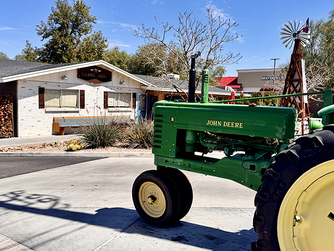 A vintage John Deere tractor stands guard outside this unassuming ranch-style building, like a green metal bouncer saying, "Only serious barbecue lovers beyond this point."