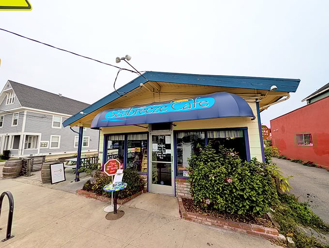 The little blue building with the bright awning isn't trying to impress anyone—until you taste what's coming out of the kitchen.