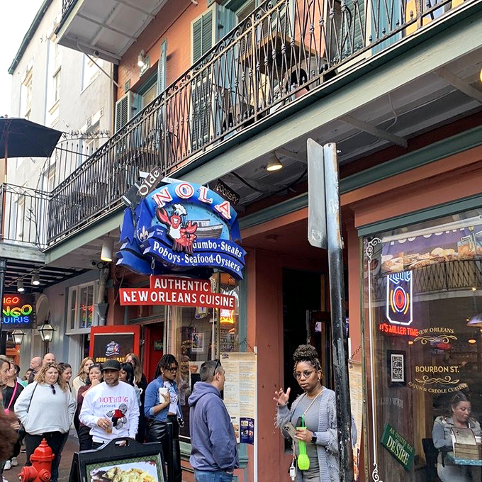That iconic blue and red sign with the jaunty crawfish isn't just decoration—it's a beacon guiding hungry souls to seafood salvation on Bourbon Street.