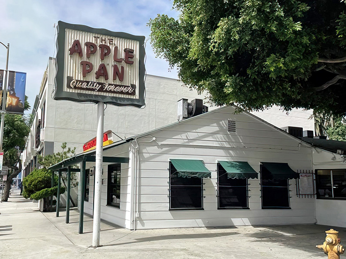 The unassuming white exterior of The Apple Pan stands like a time capsule on West Pico Boulevard, its vintage sign promising "Quality Forever" – a promise it keeps.
