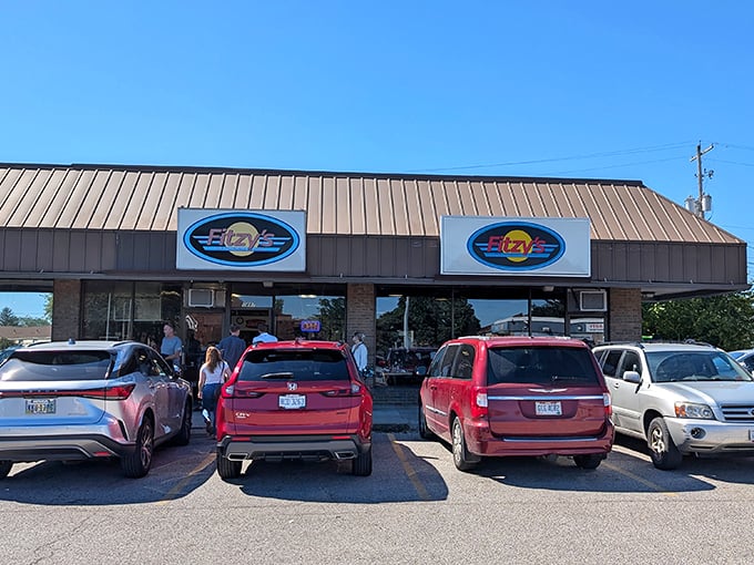The unassuming exterior of Fitzy's beckons with its blue oval signs—proof that culinary treasures often hide in plain sight.