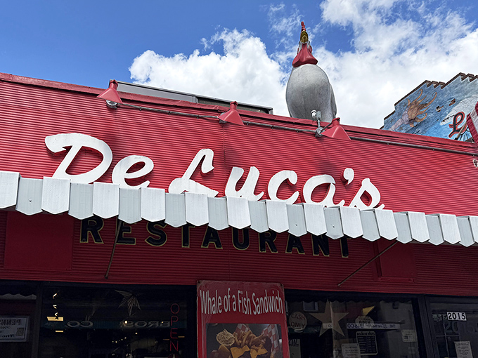 The iconic rooster stands guard atop DeLuca's vibrant red storefront, like a breakfast beacon calling hungry Pittsburghers home.