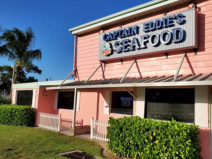 The coral-pink exterior of Captain Eddie's isn't just a building—it's a beacon calling to seafood lovers across Florida's Gulf Coast.