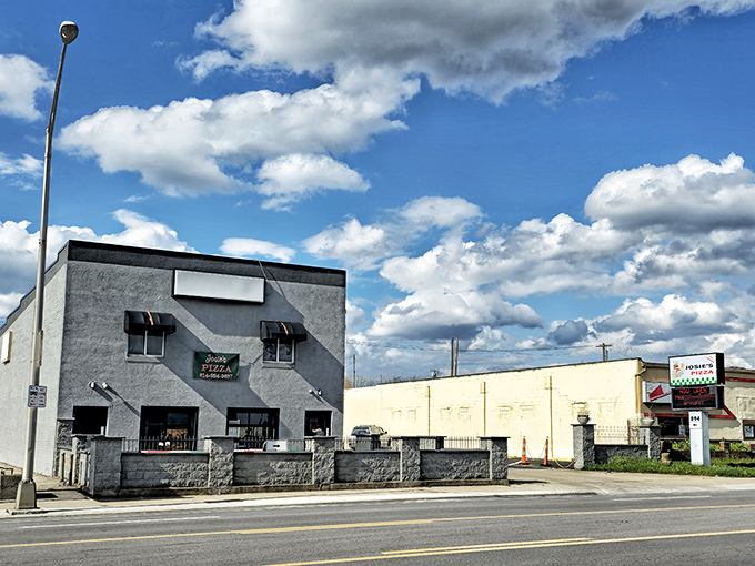 Josie’s Pizza may have a modest gray exterior, but the bright red umbrellas hint at the flavor-packed paradise waiting inside.