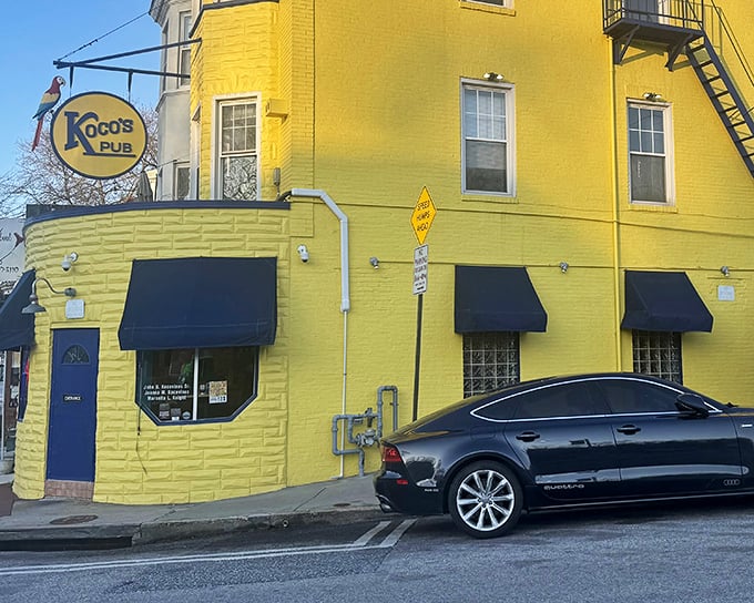 The sunshine-yellow exterior of Koco's Pub isn't just eye-catching—it's practically a lighthouse guiding hungry sailors to crab cake paradise in Baltimore's urban landscape.