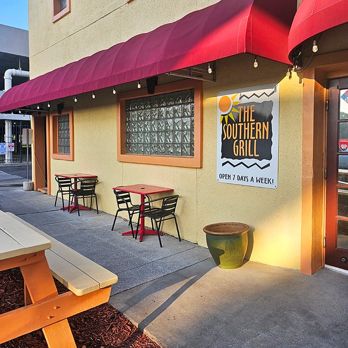 Like finding a treasure map disguised as a postcard, The Southern Grill's modest exterior with its cheerful red awning promises culinary gold within.