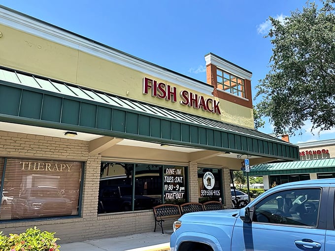 No neon signs or flashy gimmicks needed – just that glorious red lettering announcing your arrival at seafood nirvana. The bench outside? That's for contemplating your order.