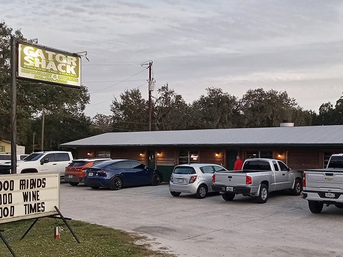 The unassuming exterior of The Gator Shack beckons with its rustic charm and a sign promising "Good Friends, Good Wine, Good Times." Florida's best secrets hide in plain sight.
