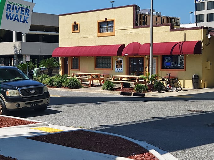 That cheerful yellow exterior with red awnings is your beacon to barbecue paradise in Jacksonville's Southbank neighborhood.