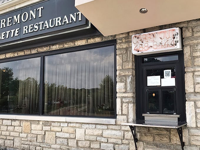 That neon "CARRY OUT" sign isn't just illuminating the entrance—it's beckoning you into a world where comfort food reigns supreme.