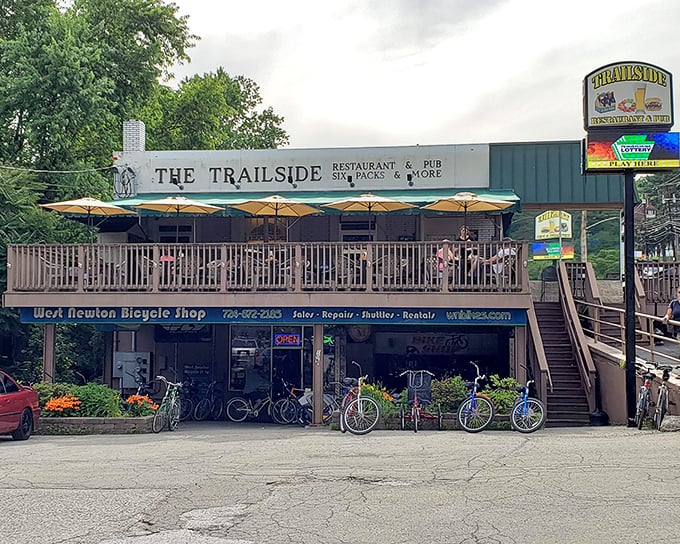 The Trailside's welcoming facade, complete with a wooden deck, beckons hungry travelers like a culinary lighthouse on the Great Allegheny Passage.