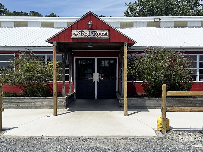 The Red Roost's barn-red exterior isn't just a color choice—it's a promise that something authentically Maryland awaits inside those doors.