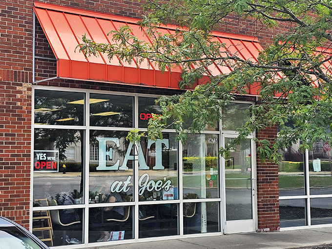 The distinctive orange awnings and welcoming storefront of Eat at Joe's – where omelet perfection awaits behind these unassuming doors.