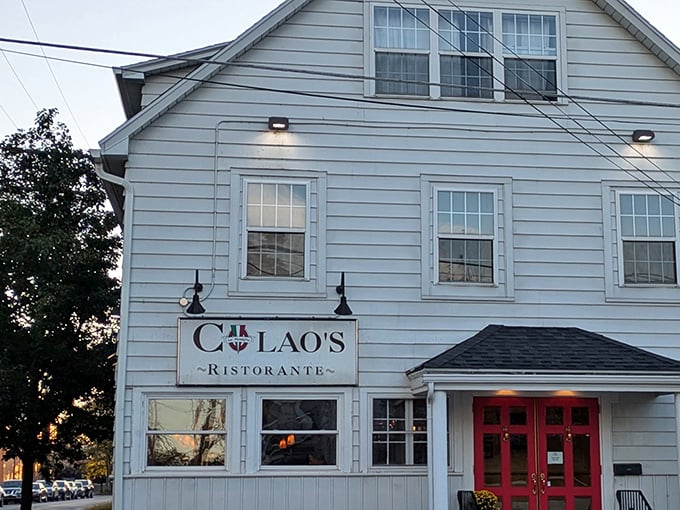 Those red doors against the white clapboard exterior aren't just an entrance – they're a portal to pasta paradise. Colao's unassuming charm hides culinary treasures within.