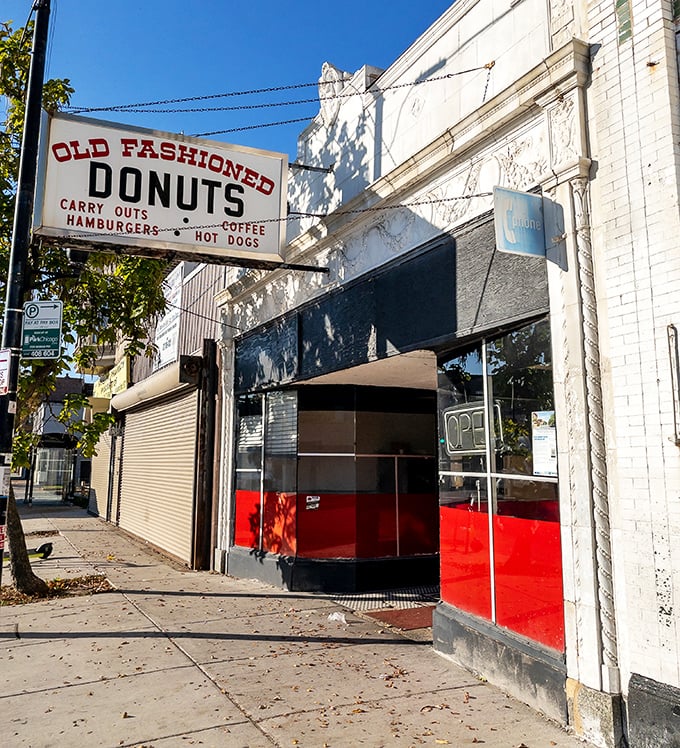 The iconic red-trimmed storefront of Old Fashioned Donuts stands as a beacon of sweet salvation on Chicago's South Side.
