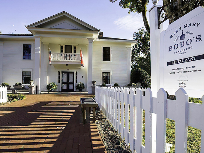 The white colonial facade of Miss Mary Bobo’s stands like a Southern sentinel, its welcoming porch and classic charm inviting guests to step inside and savor tradition.