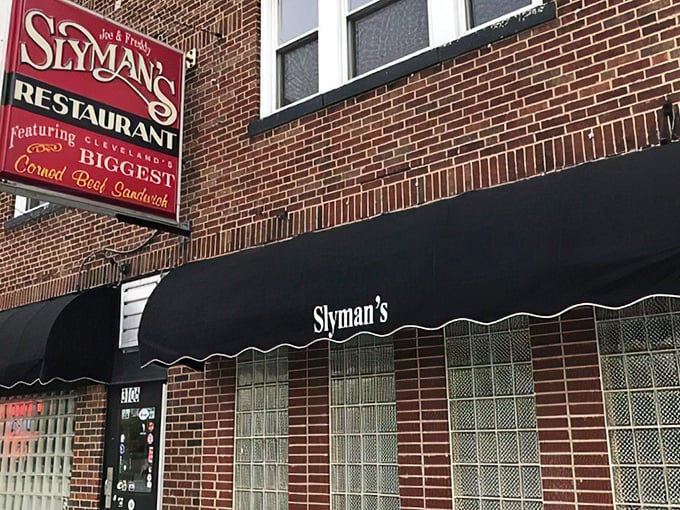 The iconic red Slyman's sign promises "Cleveland's BIGGEST Corned Beef Sandwich" – a claim that isn't hyperbole but delicious truth.