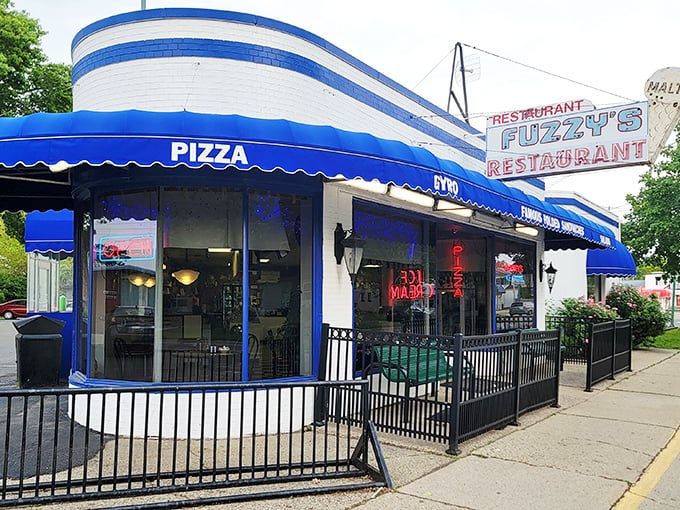 The blue and white exterior of Fuzzy's Restaurant stands like a cheerful sentinel on Saginaw's streets, promising comfort food treasures within its welcoming walls.