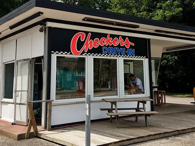 The classic black and white checkered pattern isn't just decoration—it's a promise that time-honored flavors await inside this unassuming roadside gem.