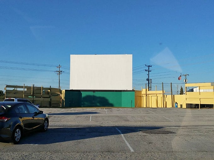 Twilight settles in as cars find their spots. The anticipation builds while the screen patiently waits for showtime.