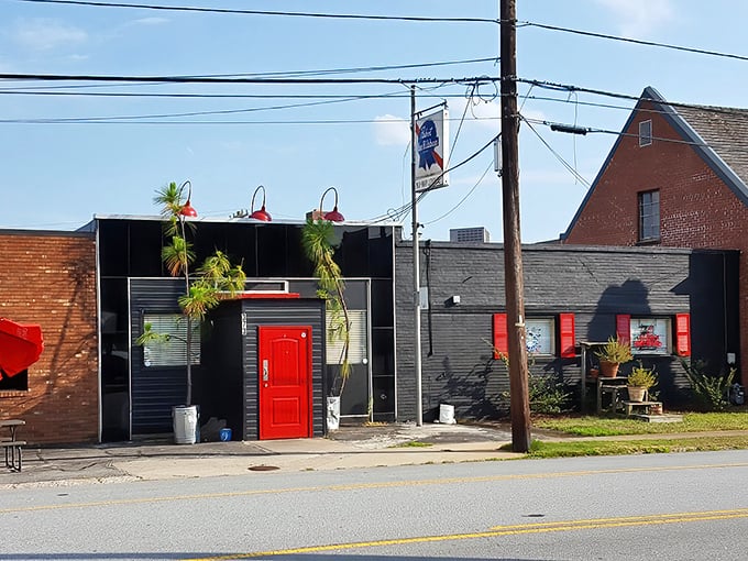 That red door isn't playing hard-to-get – it's guarding the entrance to burger paradise like a crimson sentinel of deliciousness.