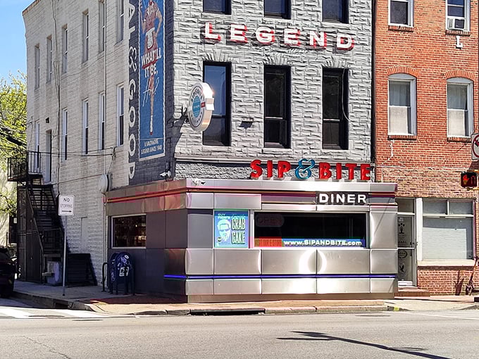 The iconic corner facade of Sip & Bite stands like a beacon of comfort food hope in Baltimore's Canton neighborhood, its stainless steel exterior gleaming with decades of diner history.