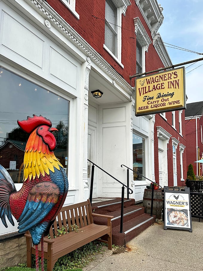 The iconic red brick facade of Wagner's Village Inn, complete with colorful rooster statue standing guard over what might be Indiana's best-kept culinary secret.