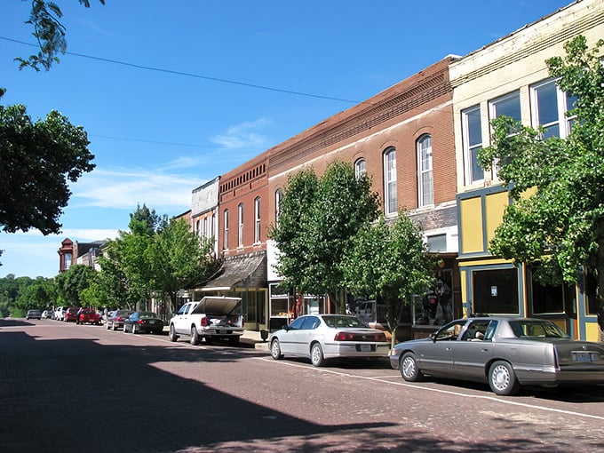 Historic brick buildings stand sentinel on Fulton's Court Street, where time seems to slow down just enough to notice architectural details modern buildings forgot.