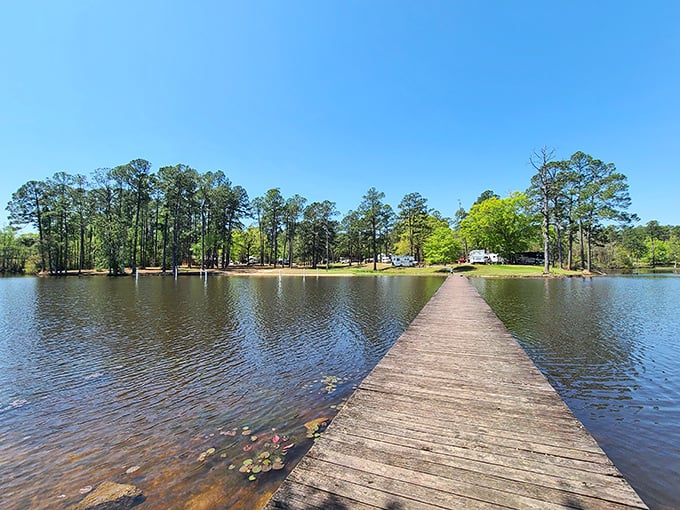 That wooden pier stretching into Geiger Lake isn't just a walkway—it's an invitation to leave your worries on the shore and step into Mississippi tranquility.
