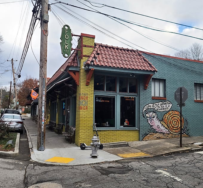 The teal and yellow building with its whimsical snail mural isn't just eye-catching—it's a beacon for hungry Atlantans seeking breakfast nirvana in Inman Park.