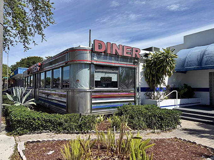 The gleaming stainless steel exterior of Jack's Hollywood Diner catches Florida sunshine like a time machine that happens to serve breakfast. Classic Americana at its finest.