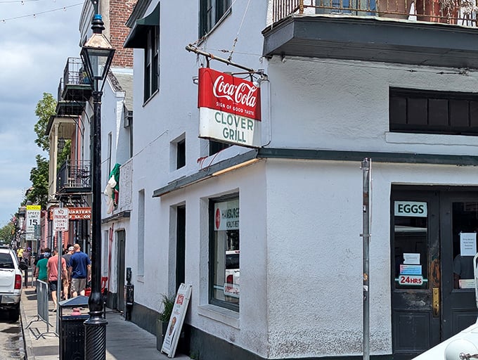 The corner of Bourbon and Dumaine reveals this unassuming treasure – where the vintage Coca-Cola sign and "EGGS" window promise breakfast salvation 24 hours a day.