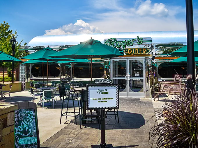 Green umbrellas dot the spacious patio like islands of shade, inviting you to savor your burger while soaking in Mill Spring's peaceful charm.