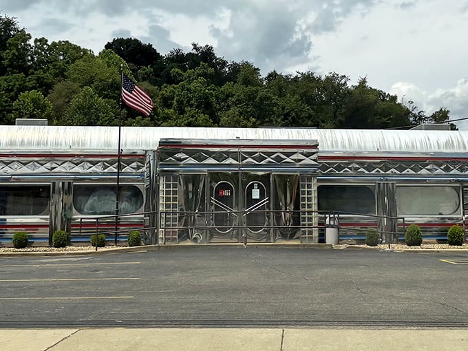 Chrome dreams come true! This gleaming silver exterior with its classic curved roof and American flag stands as a shining beacon of roadside Americana on Route 23.