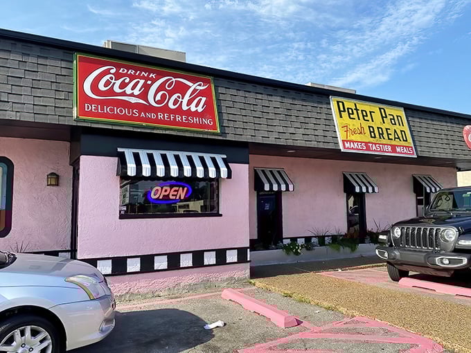 The pink palace of breakfast dreams stands proudly with its vintage Coca-Cola and Peter Pan bread signs—a time capsule you can actually eat in.