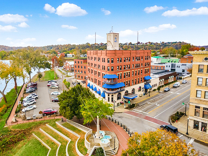 The historic Lafayette Hotel stands proudly on the riverfront, its distinctive brick facade and blue awnings welcoming travelers seeking a taste of old-world hospitality.