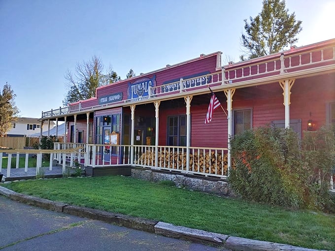 The Wild West meets culinary excellence at Tumalo Feed Company's iconic red exterior. Those hanging flower baskets aren't just for show—they're welcoming you to steak paradise.