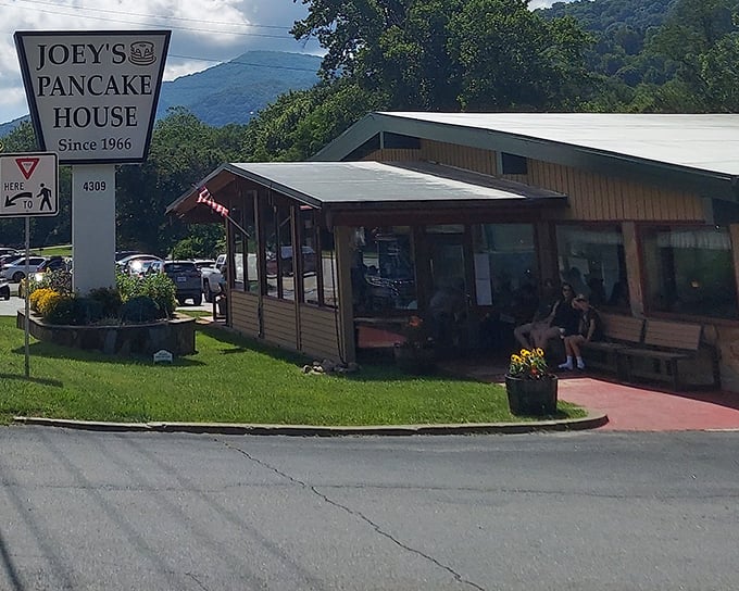 Joey's iconic roadside sign welcomes hungry travelers like a breakfast lighthouse guiding ships to shore. The mountains provide a perfect backdrop for pancake perfection.