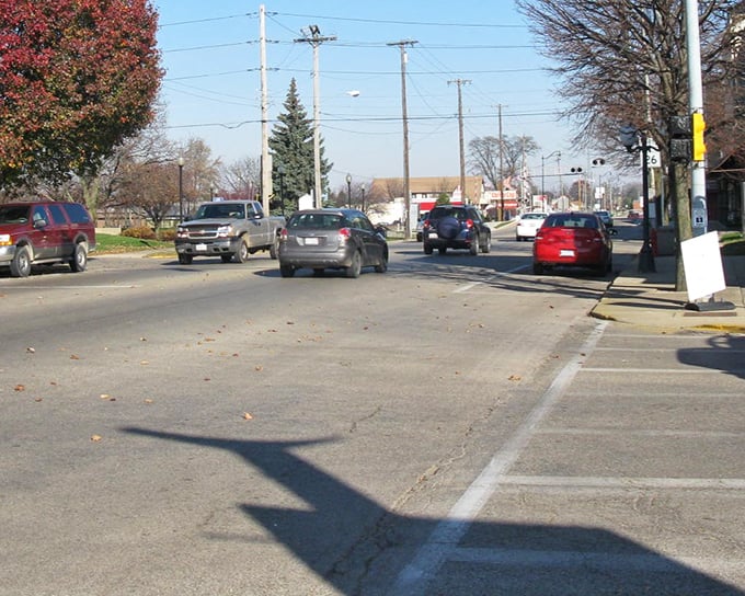 Main Street traffic flows through Princeton, where autumn trees add splashes of color to this quintessential Midwest thoroughfare.