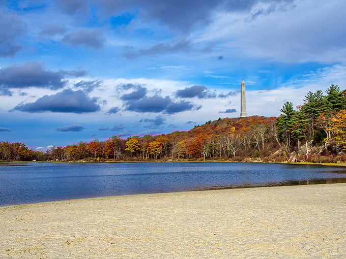 Lake Marcia's autumn splendor creates nature's perfect mirror, with the High Point Monument standing sentinel over this peaceful New Jersey retreat.