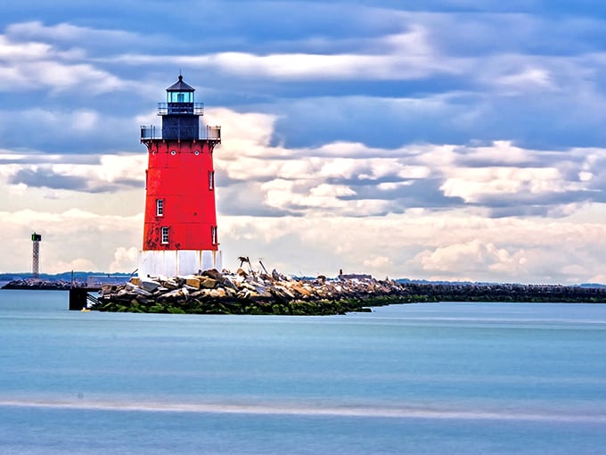 Candy-apple red against azure waters, the East End Lighthouse pops like maritime artwork on Delaware's aquatic canvas.