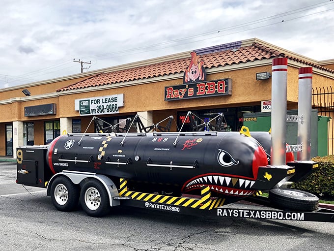 The shark-painted smoker outside Ray's Texas BBQ isn't just eye-catching—it's a warning that serious barbecue lurks within these unassuming strip mall walls.