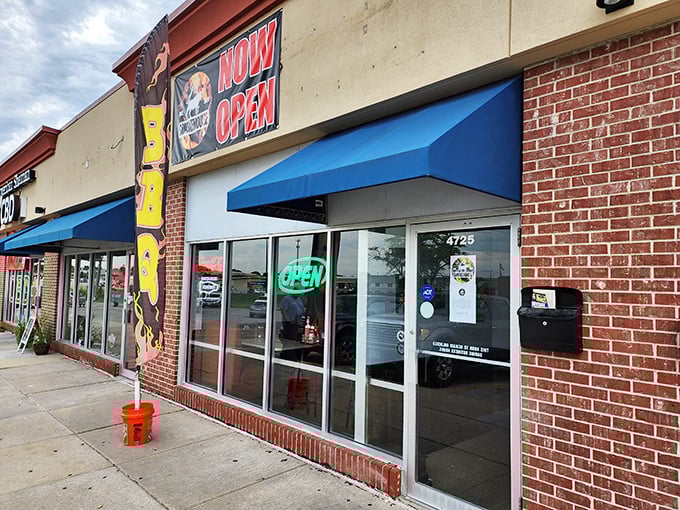 The unassuming storefront might not scream "barbecue paradise," but your nose will know better. Blue awnings and a simple sign—culinary treasures often hide in plain sight.