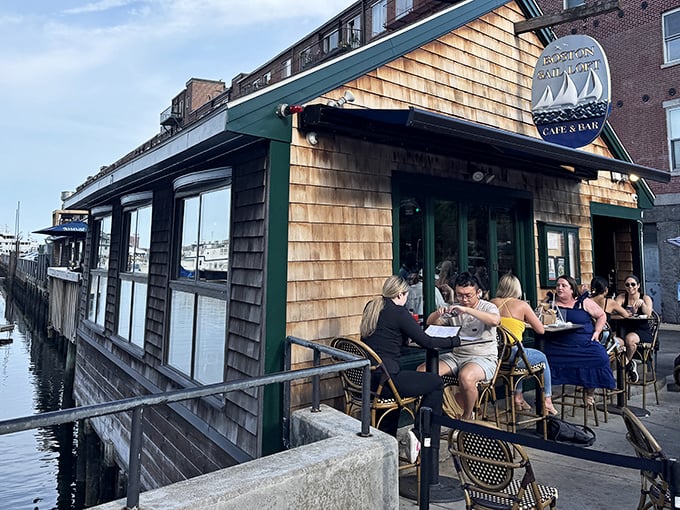 The quintessential New England seafood shack experience—cedar shingles, harbor views, and happy diners soaking up sunshine on the waterfront deck.