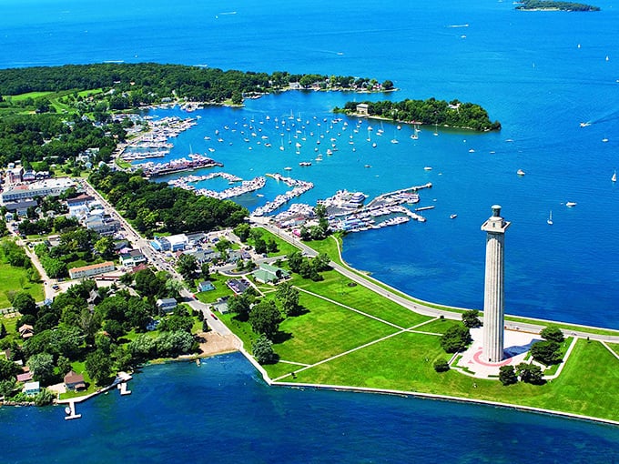 Aerial paradise! Put-in-Bay's harbor sparkles like a sapphire, dotted with boats and framed by Perry's Monument—the Midwest's answer to island getaways.