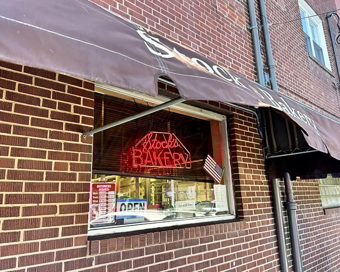 The unassuming brick façade of Stock's Bakery hides Philadelphia's sweetest secret. That neon sign is like a lighthouse guiding sugar-seeking souls to buttercake paradise.